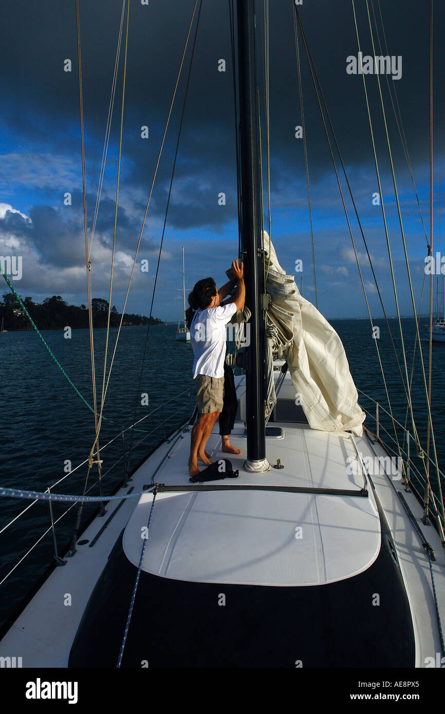 Setting sail - couple hoisting the main sail on a sailing yacht Stock ...