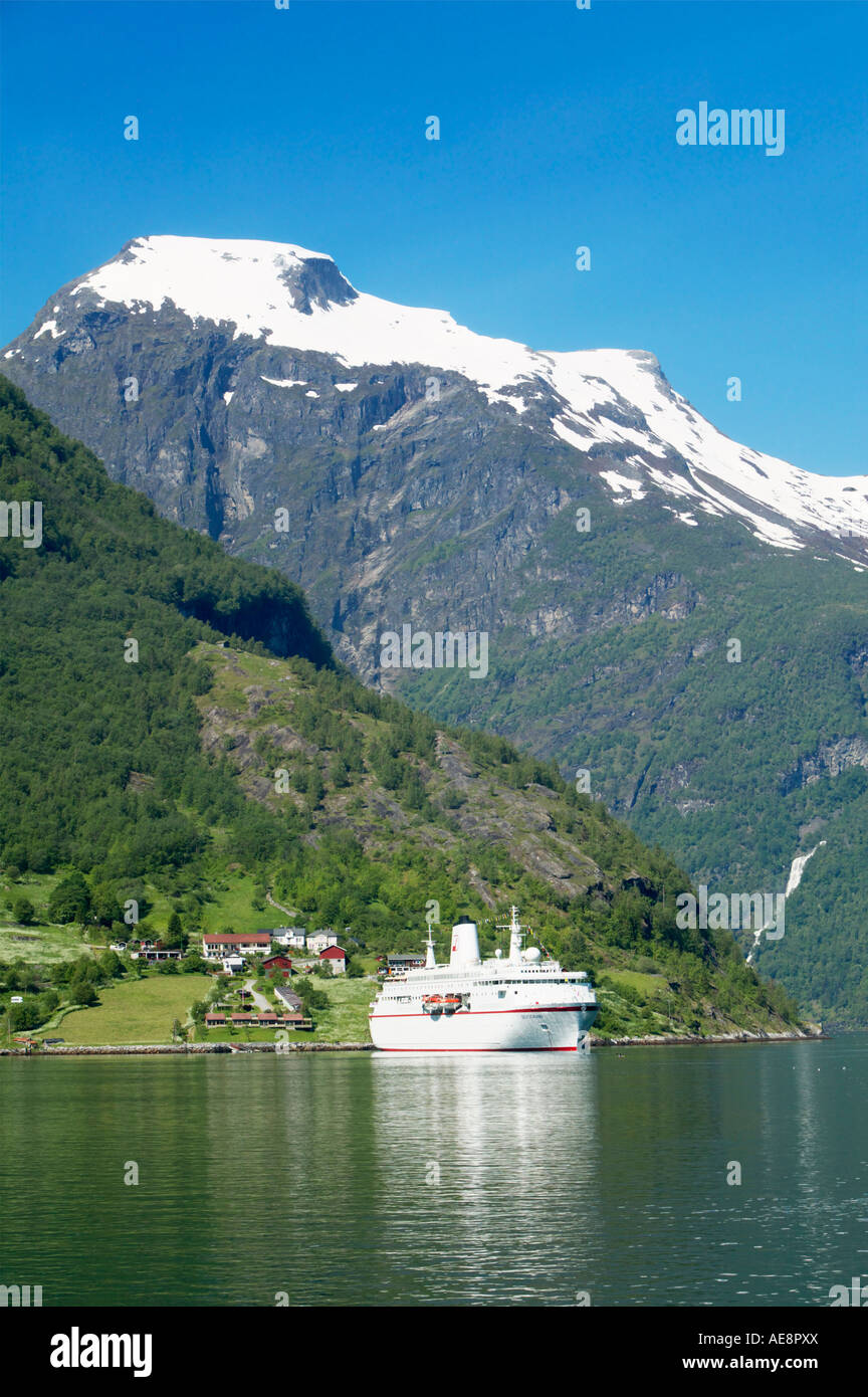 A cruise ship anchored off Geiranger in the Geirangerfjorden Stranda ...