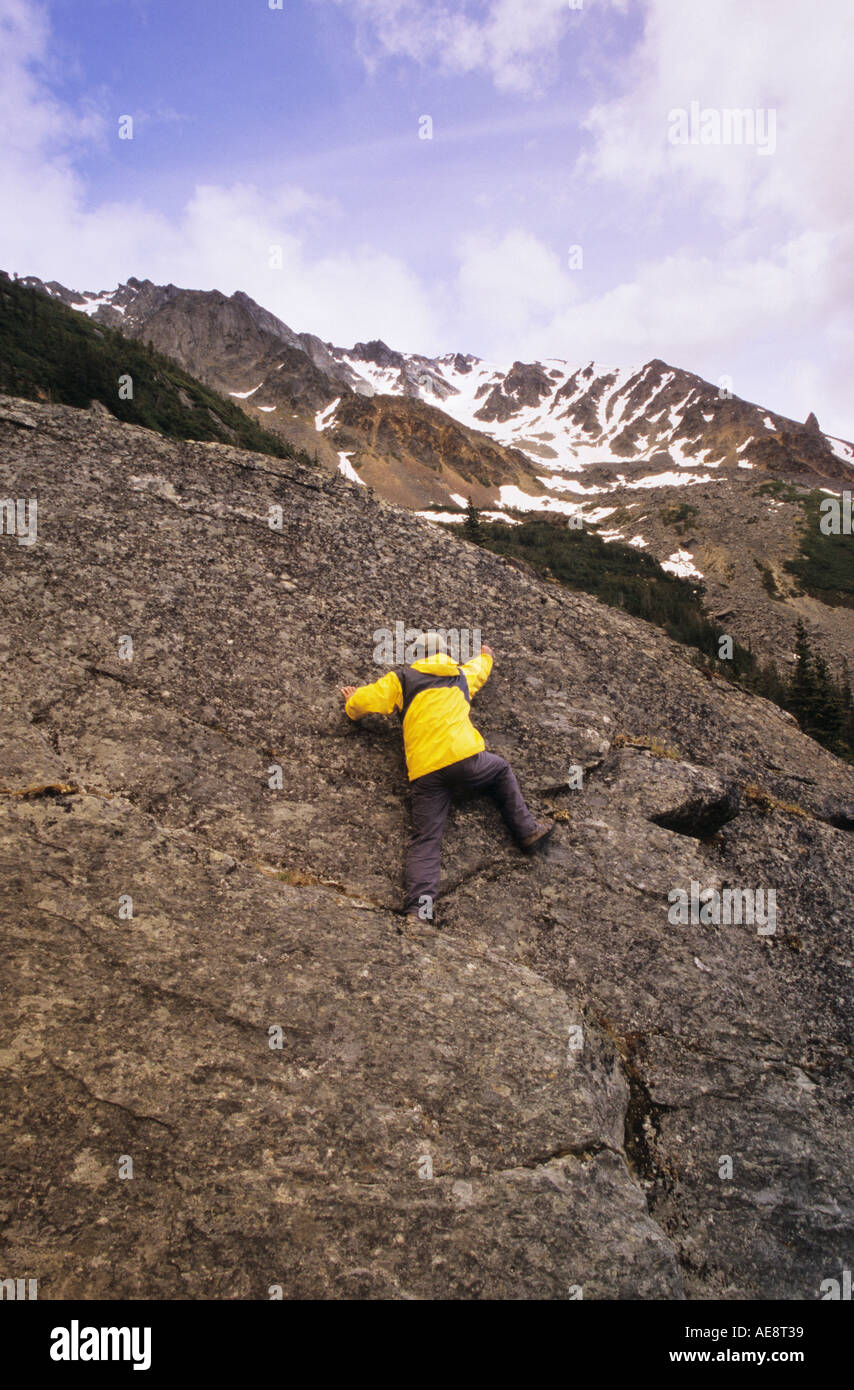 Hiker climbing rock face Danny Moore Basin Babine Mountains Provincial ...