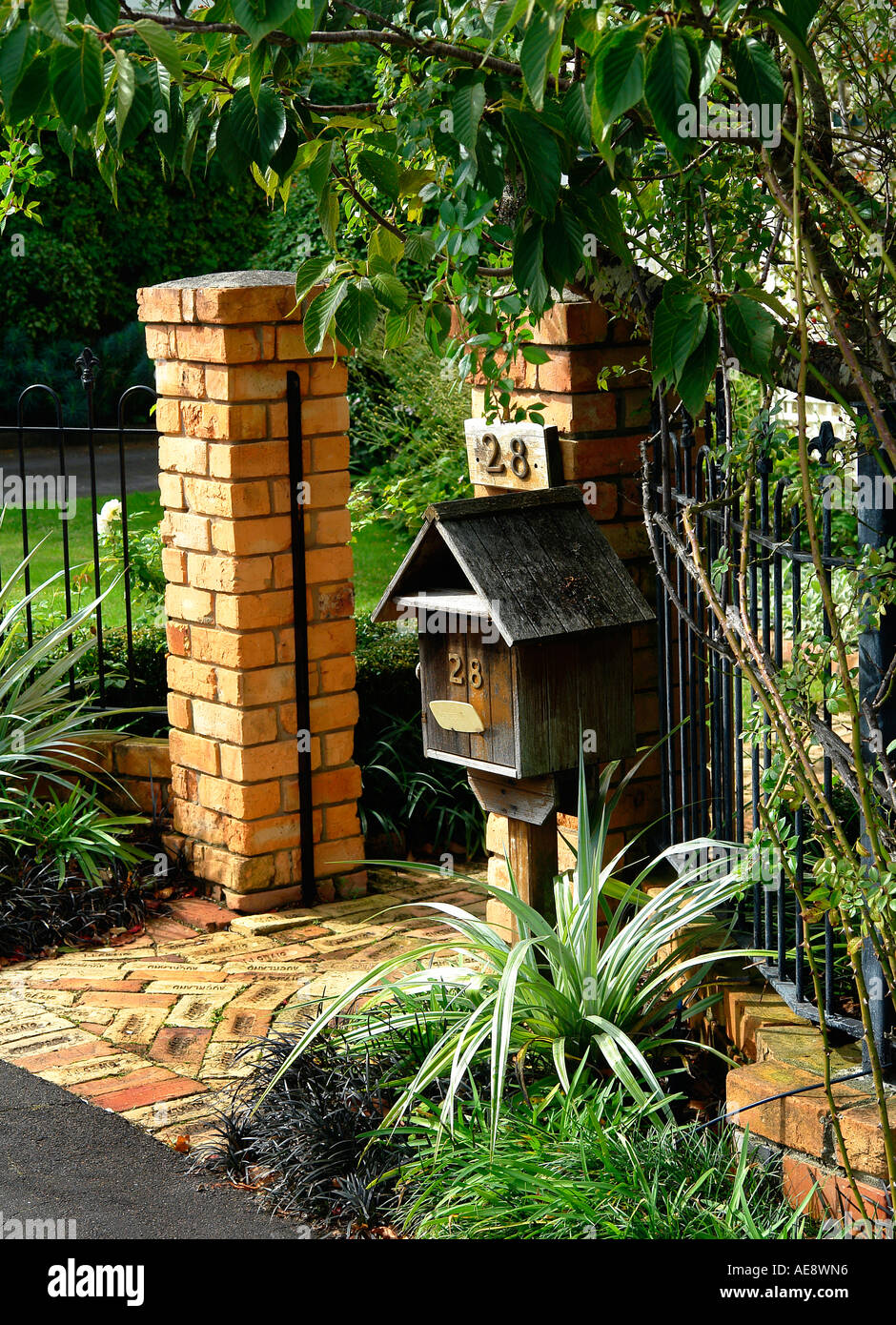 Brick gatepost and mailbox at entrance to house Stock Photo - Alamy