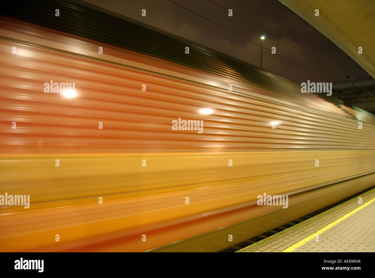 Train passing by station platform at high speed Stock Photo - Alamy