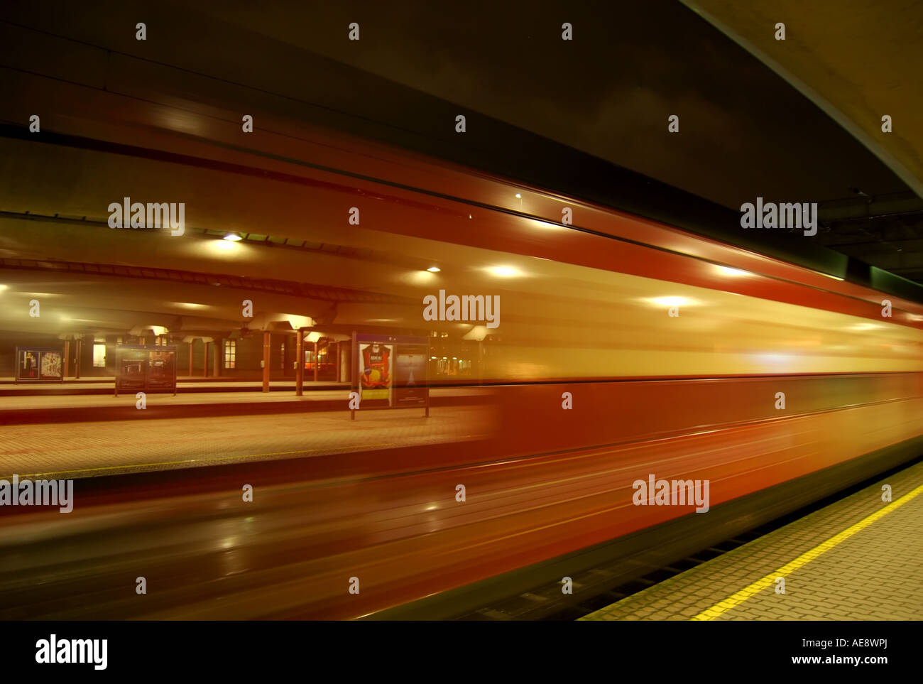 Train passing by station platform at high speed Stock Photo - Alamy