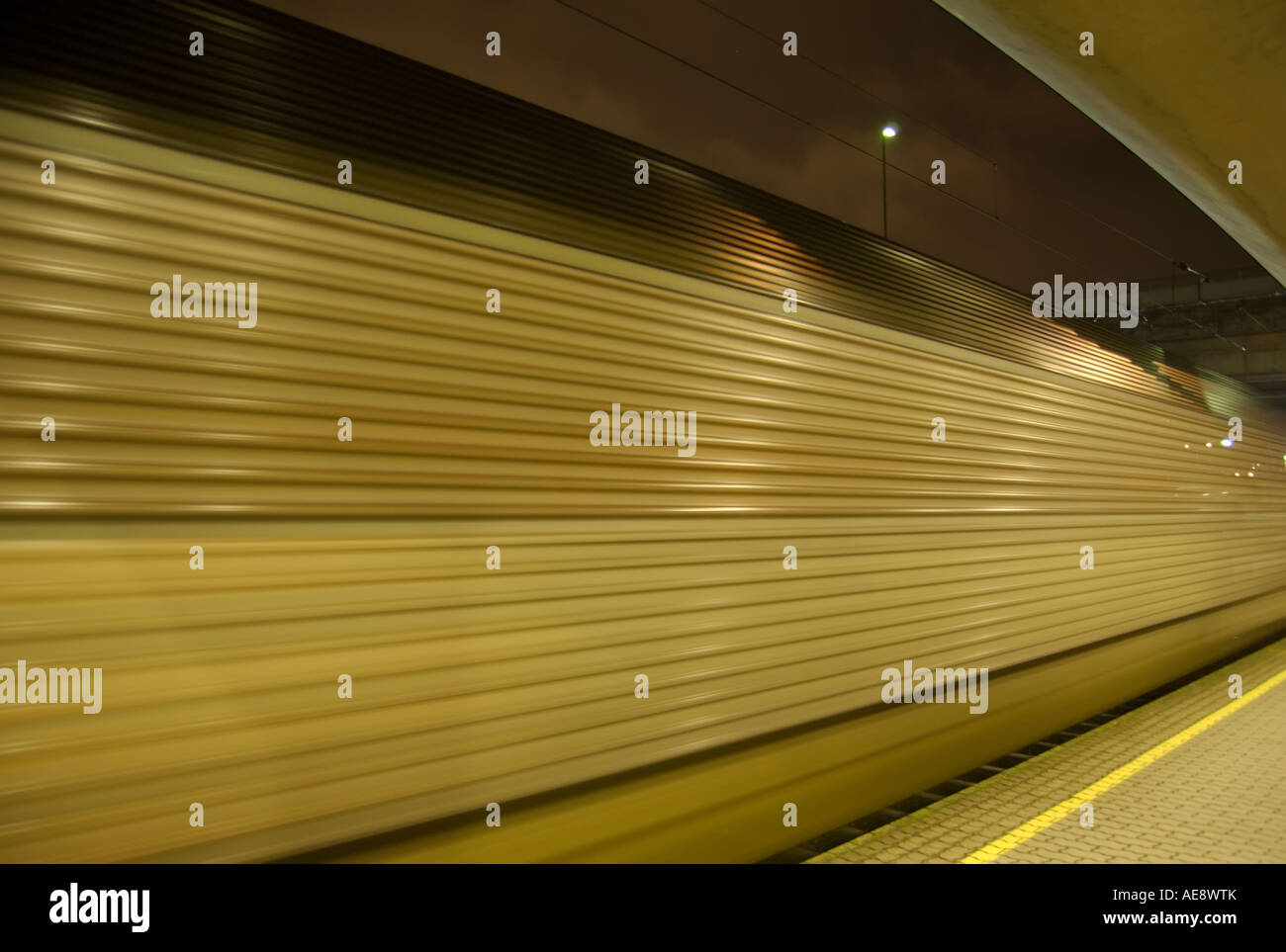 Train passing by station platform at high speed Stock Photo - Alamy