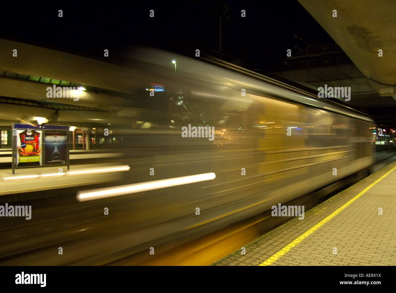 Train passing by station platform at high speed Stock Photo - Alamy