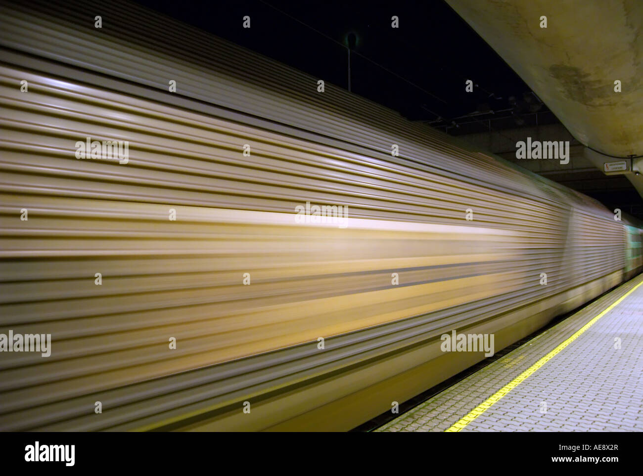 Train passing by station platform at high speed Stock Photo - Alamy