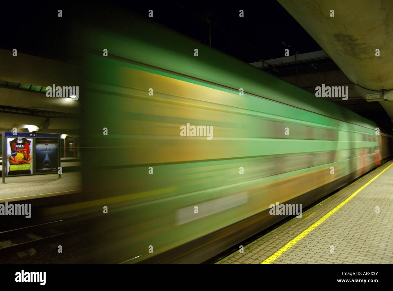 Train passing by station platform at high speed Stock Photo - Alamy