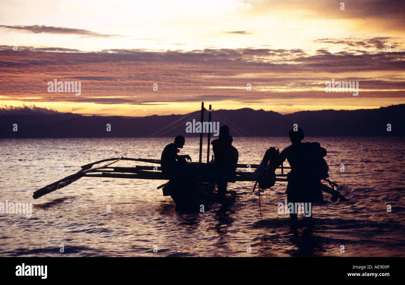 Setting off for a night dive in an outrigger canoe Philippines Stock ...