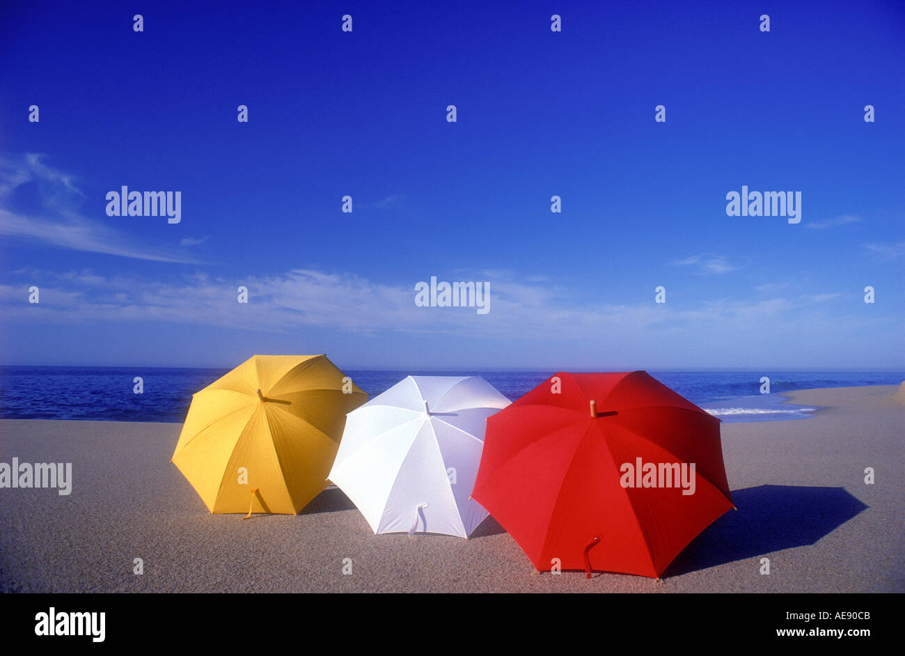 Three umbrellas on the beach Property released image Stock Photo - Alamy