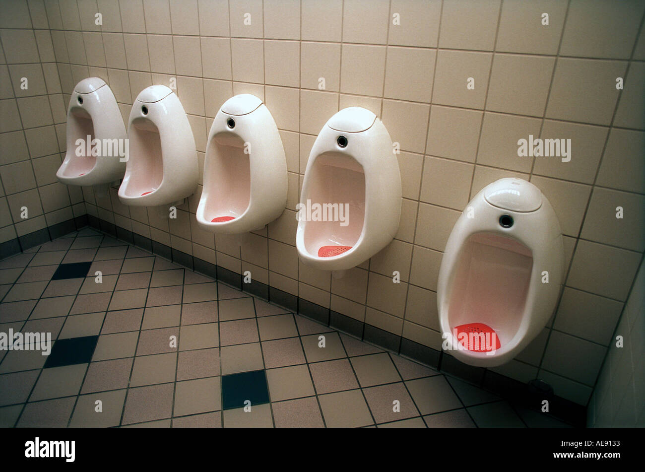 Row of urinals in public restroom Stock Photo - Alamy