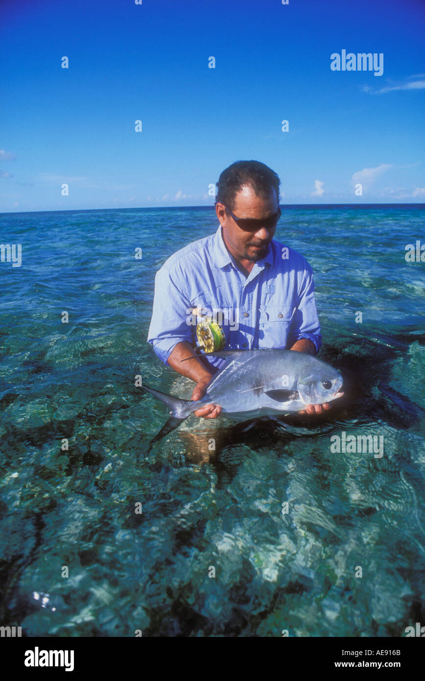 Man holding permit fish caught while fly fishing in southern Belize ...