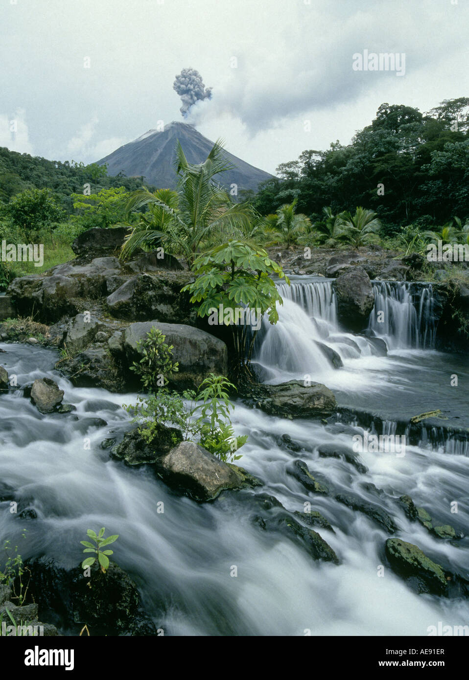 A rain forest waterfall tumbles down from the bowels of Arenal Volcano ...