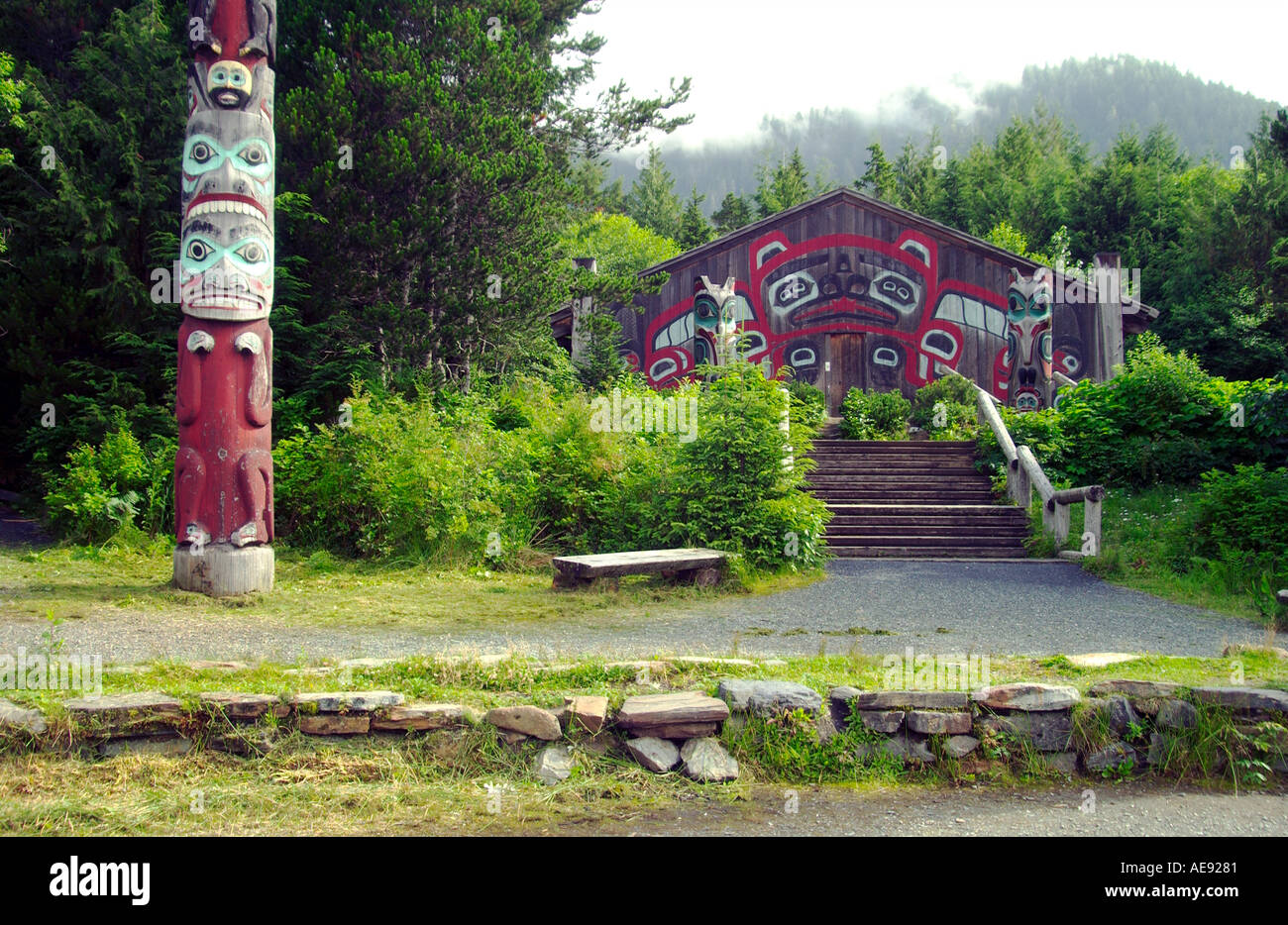 Totem poles and longhouse in Saxman Village near Ketchikan, Alaska, USA ...