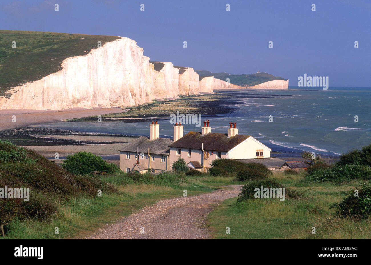THE SEVEN SISTERS CLIFFS SUSSEX ENGLAND WITH COTTAGES IN THE FOREGROUND ...