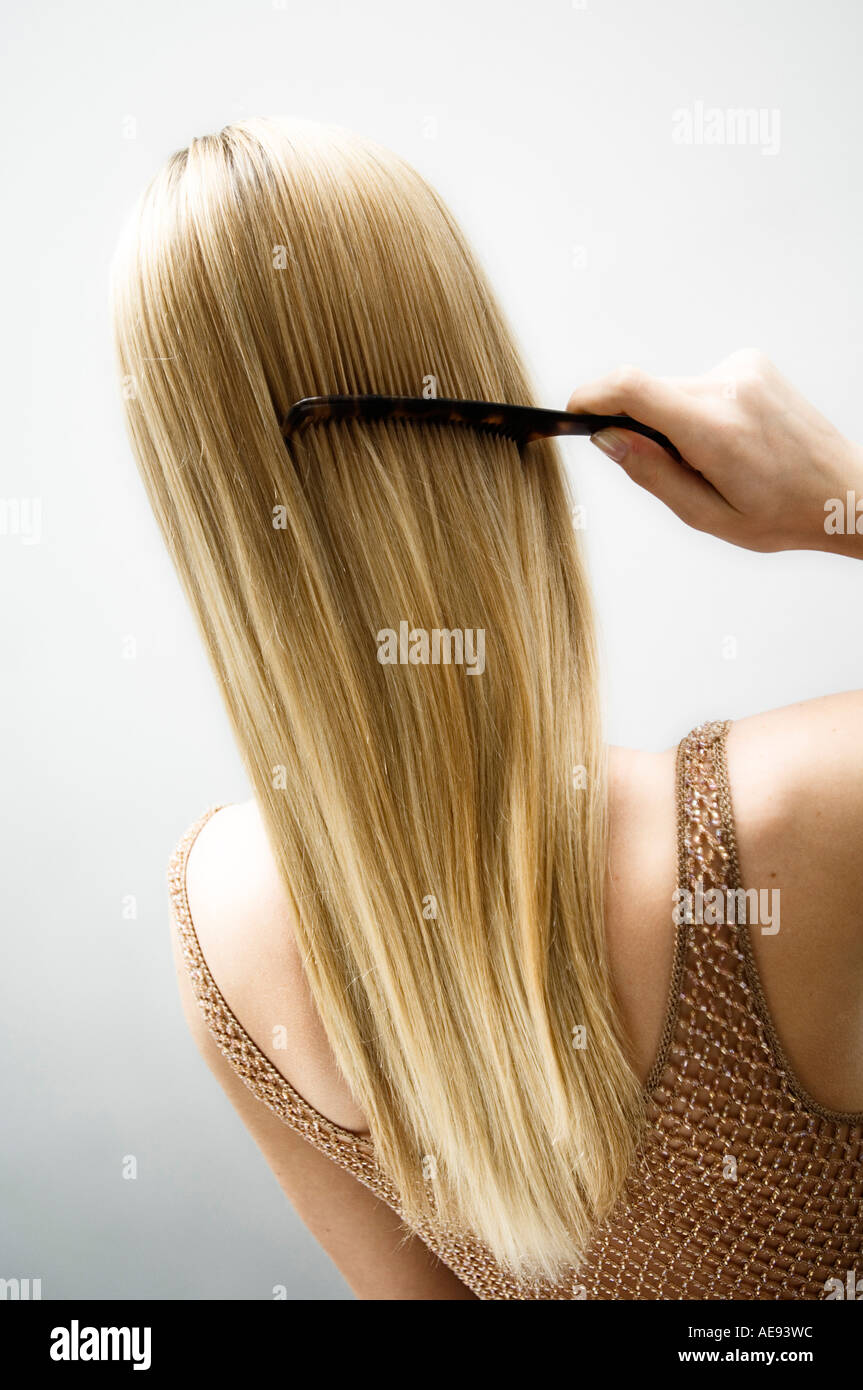 Young woman combing her hair, view from the back Stock Photo - Alamy