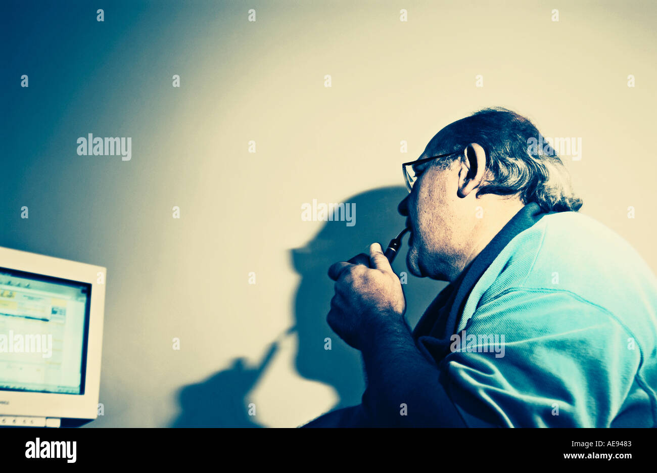 portrait of a man smoking a pipe in front of his computer Stock Photo ...