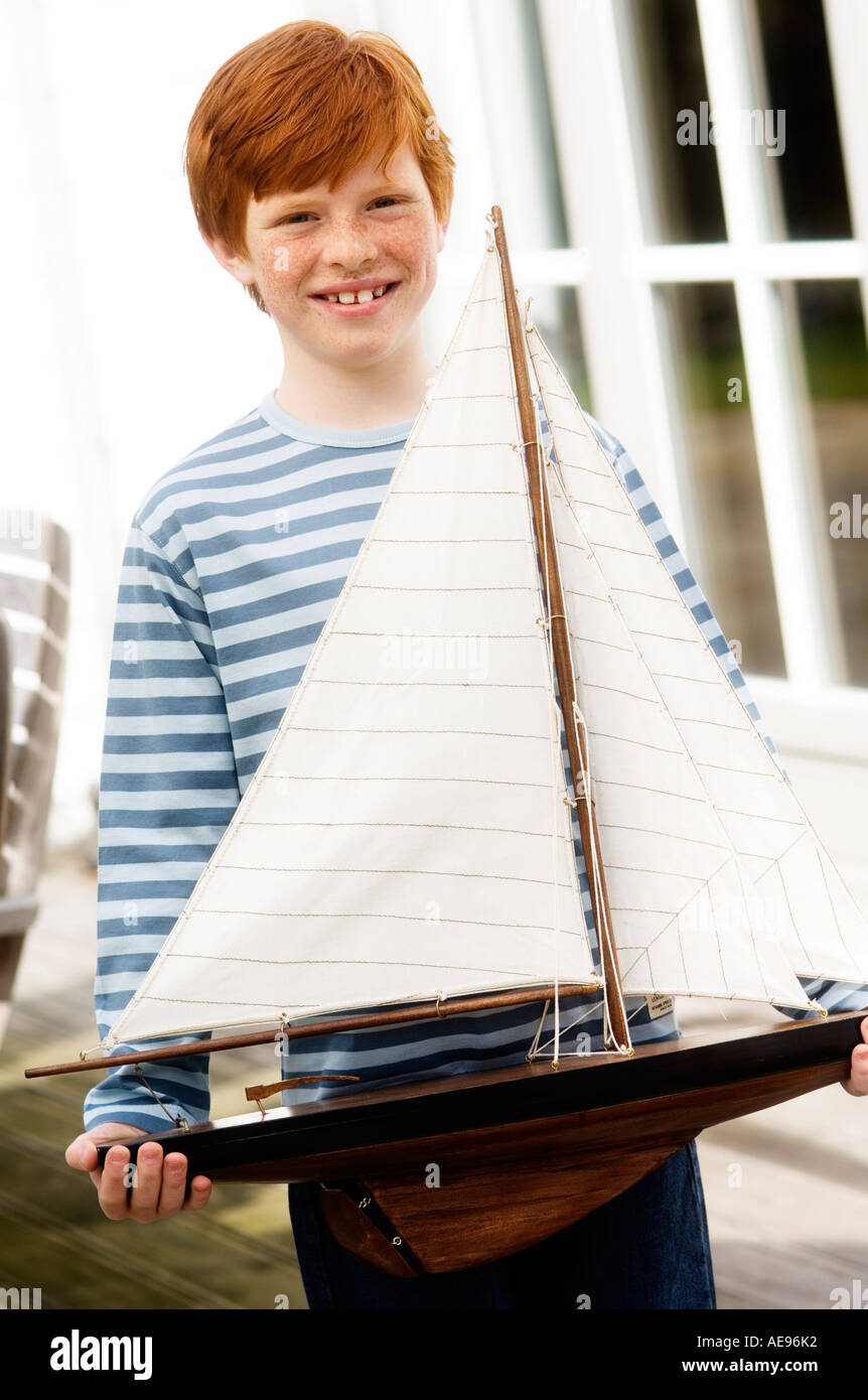 Boy holding a model boat Stock Photo - Alamy