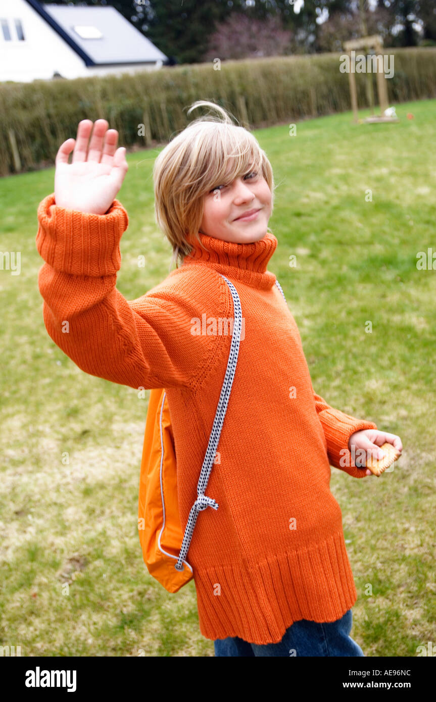Boy in garden saying goodbye Stock Photo - Alamy