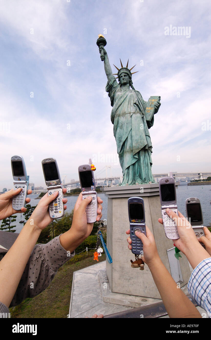 Visitors using camera phones at the Tokyo copy of the Statue of Liberty ...