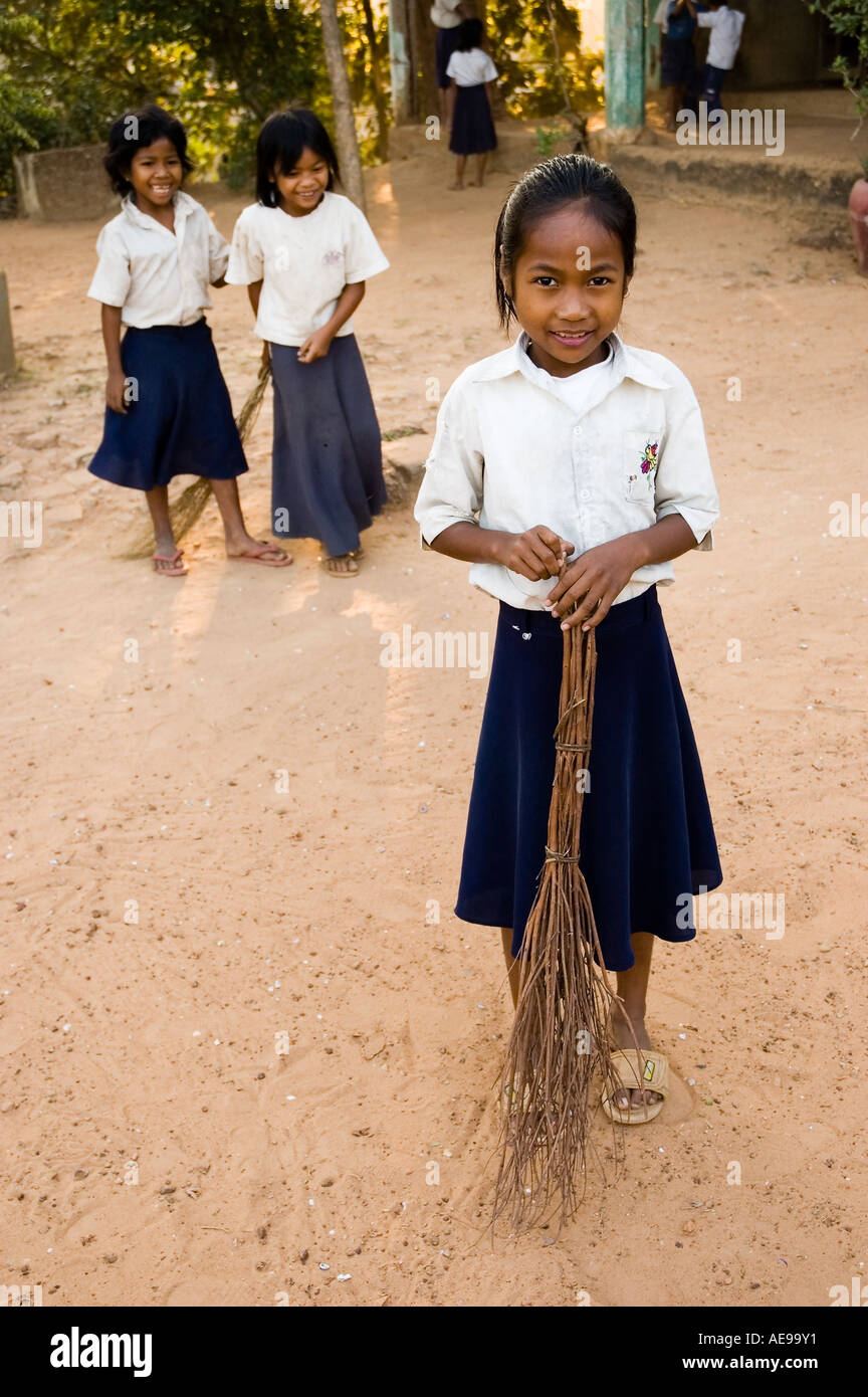 Stock photo of elementary school students sweeping up in a schoolyard ...
