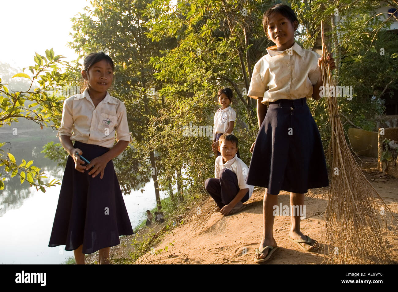Stock photo of elementary school students sweeping up in a schoolyard ...