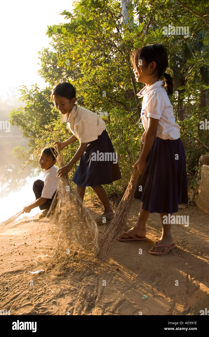 Stock photo of elementary school students sweeping up in a schoolyard ...