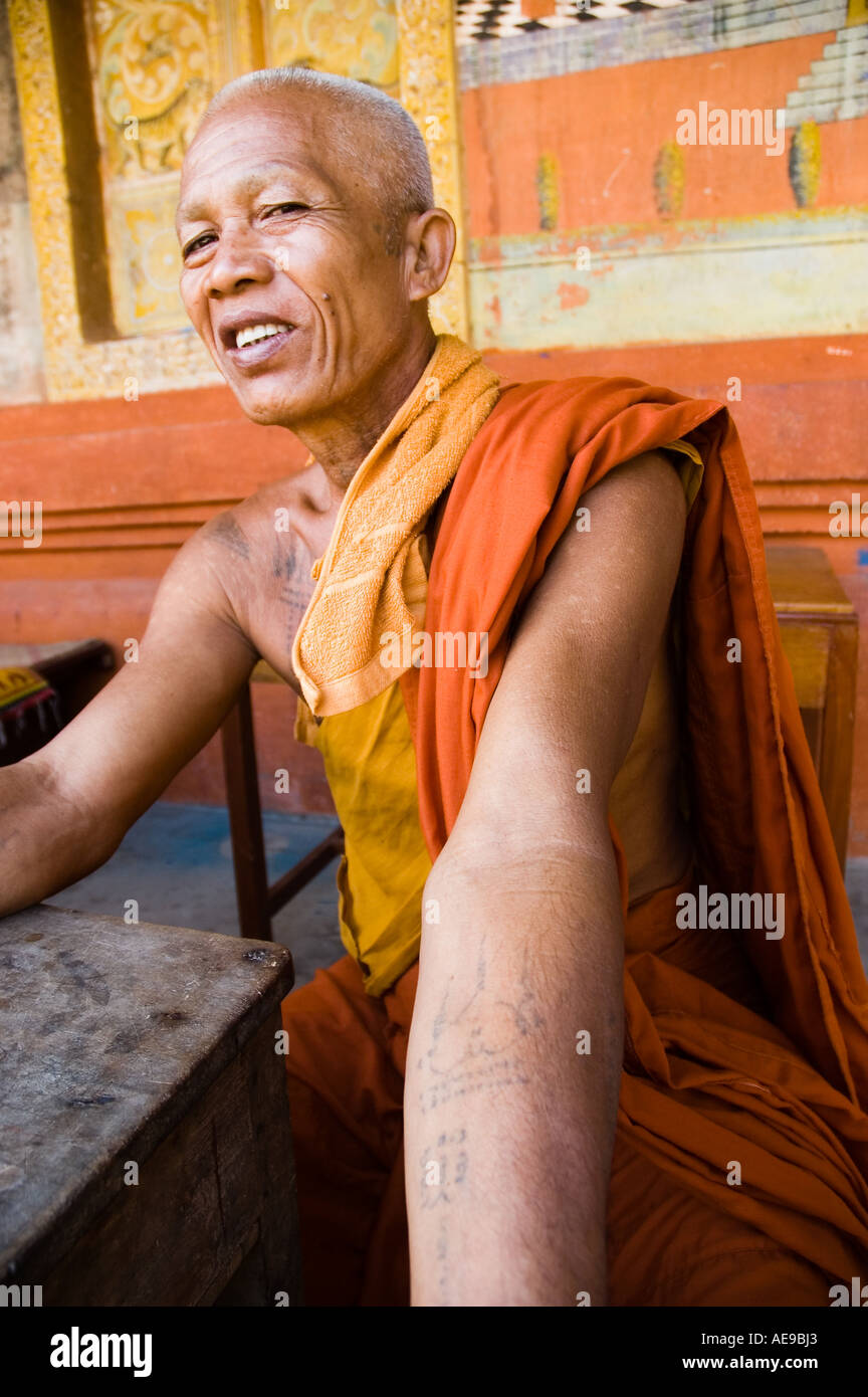 Stock photo of an elder monk displaying his tattoos at Bakong Monastery ...