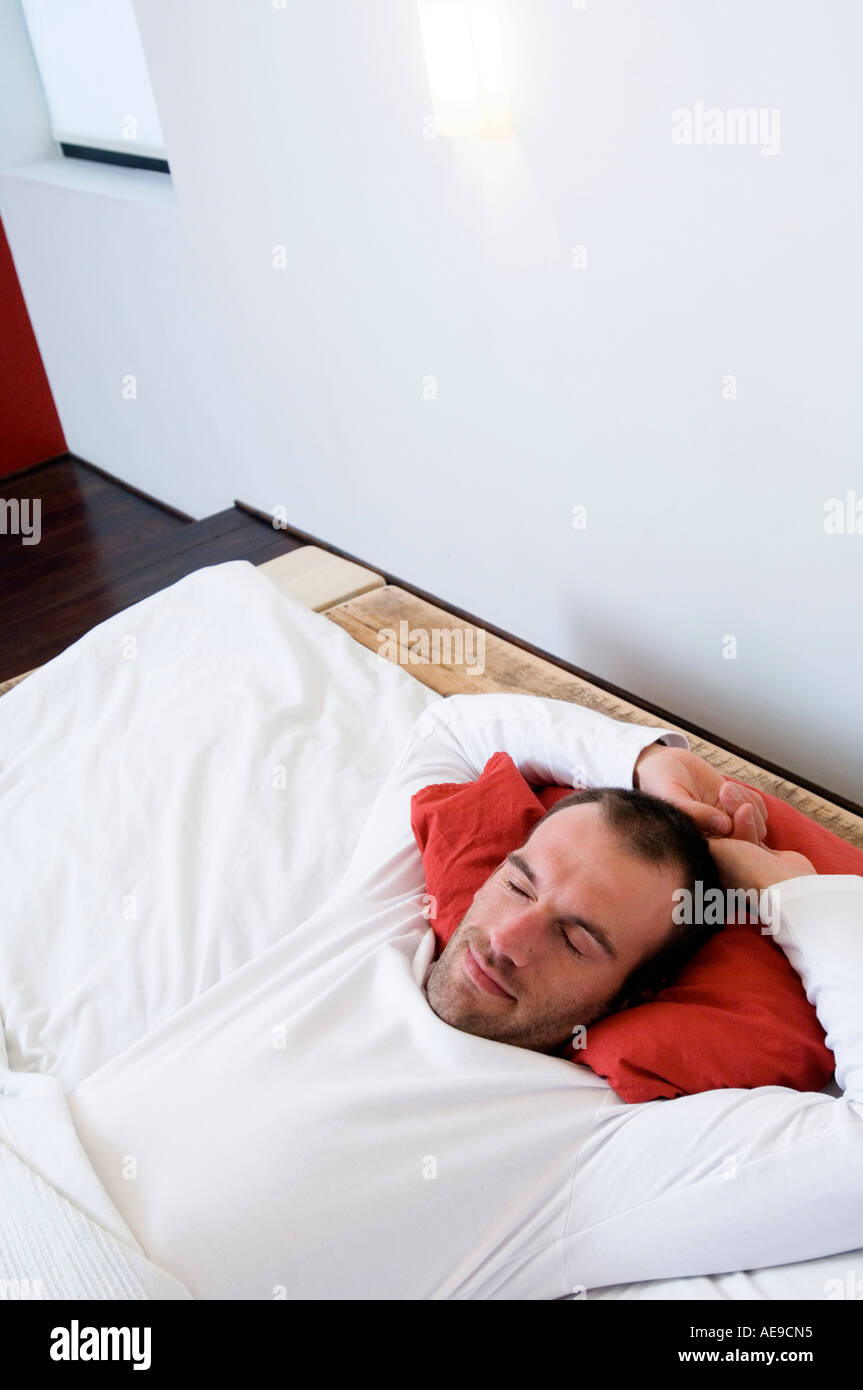 Man stretching in bed Stock Photo - Alamy