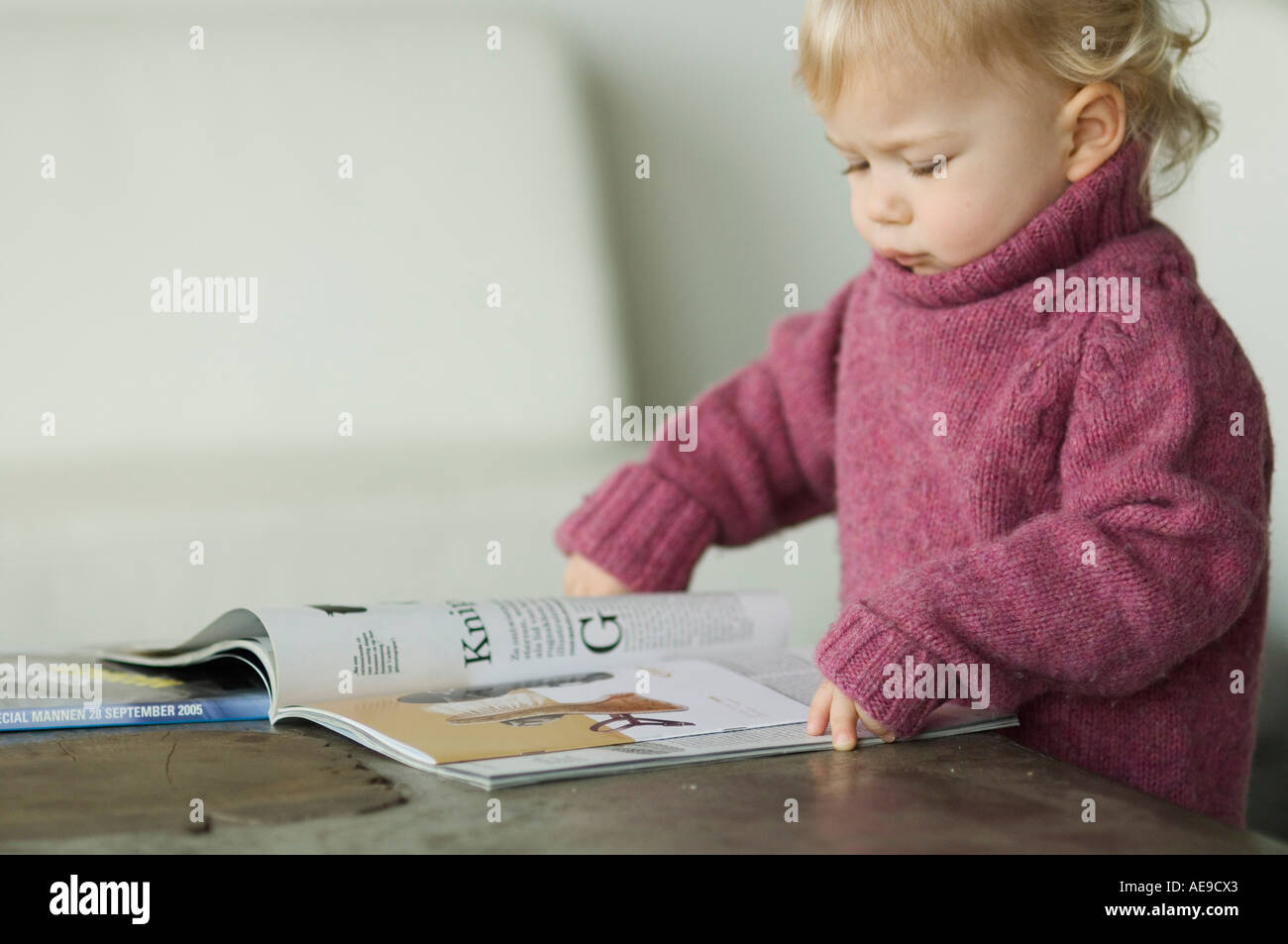 Little boy reading a magazine Stock Photo - Alamy
