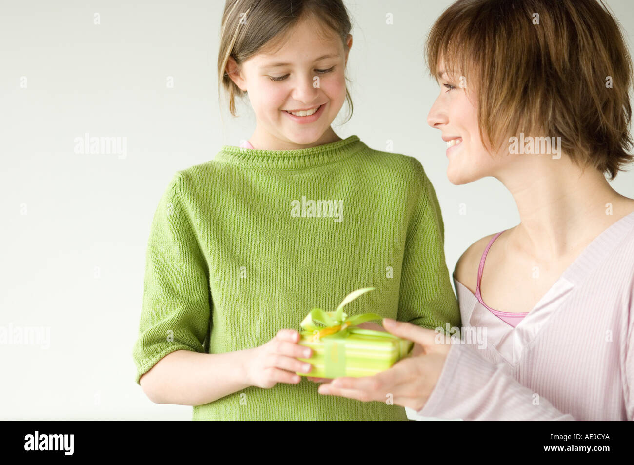 Woman giving a present to little girl Stock Photo - Alamy