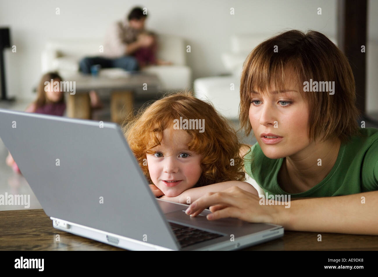 Woman and little girl using laptop computer Stock Photo - Alamy