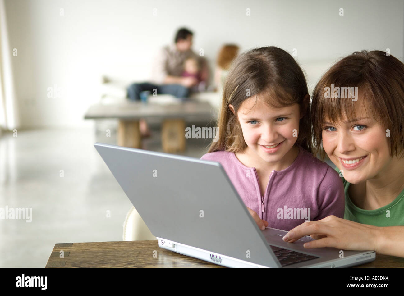 Woman and little girl using laptop computer Stock Photo - Alamy