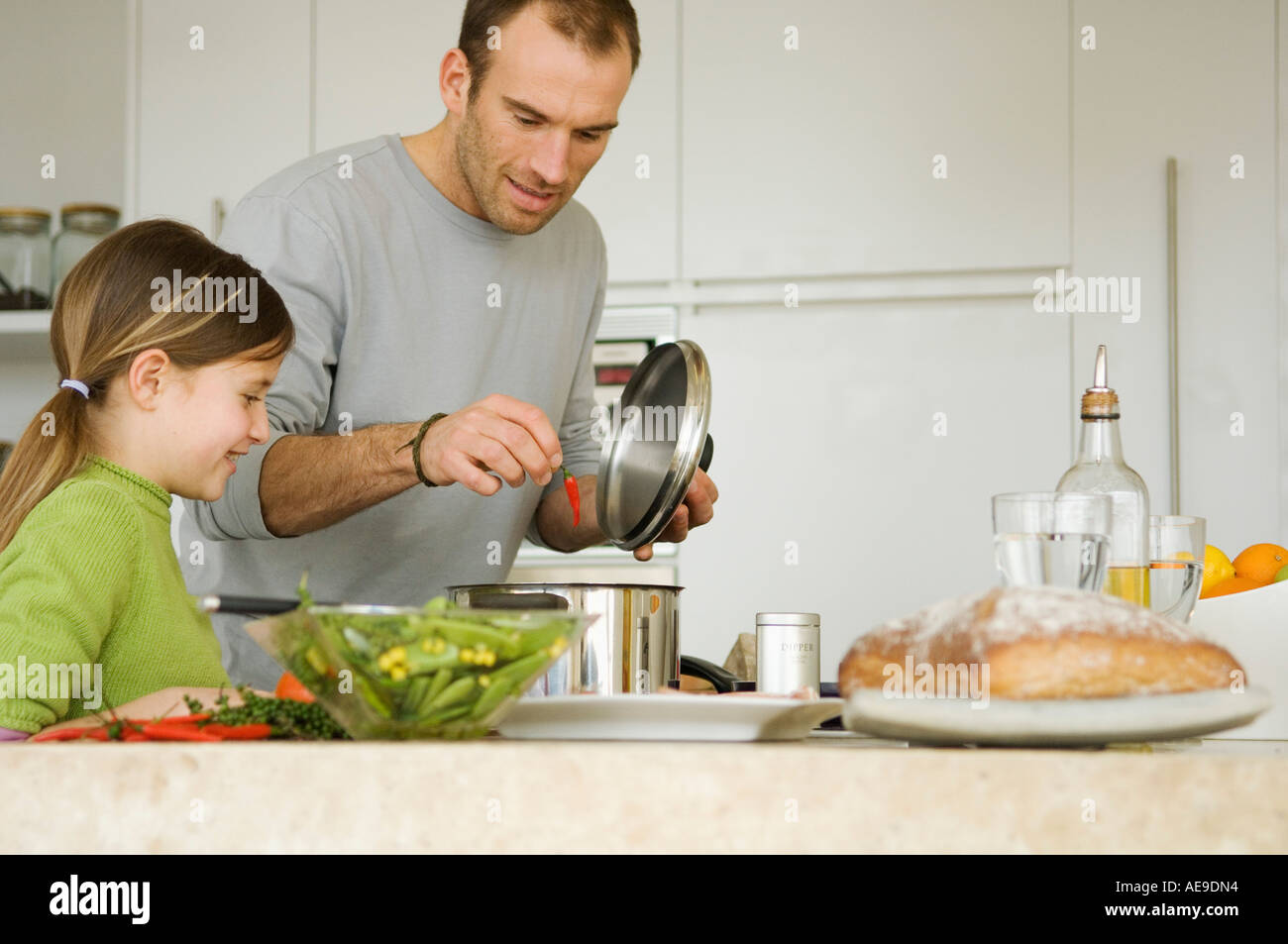 Man and little girl cooking Stock Photo - Alamy