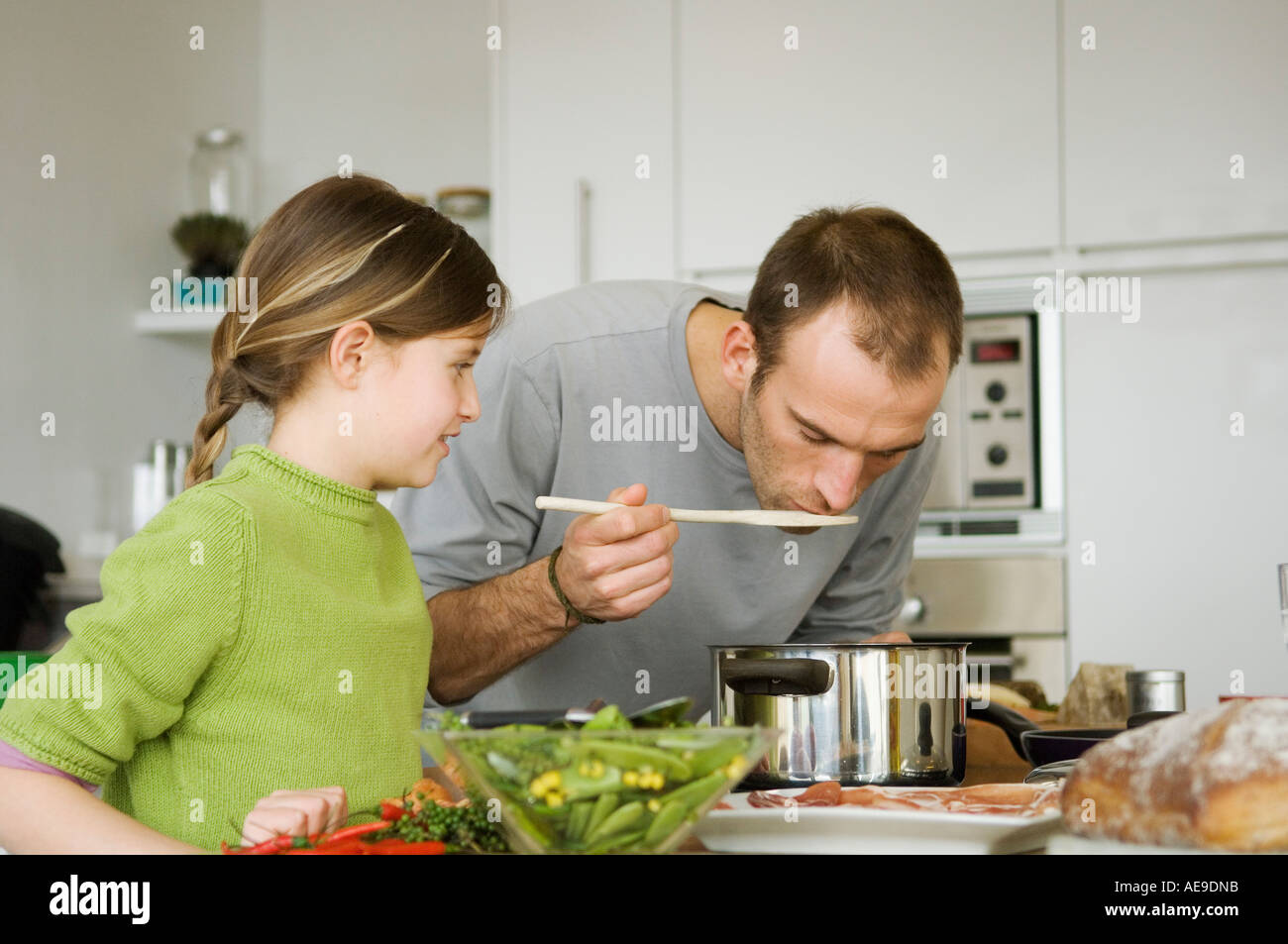 Man and little girl cooking Stock Photo - Alamy