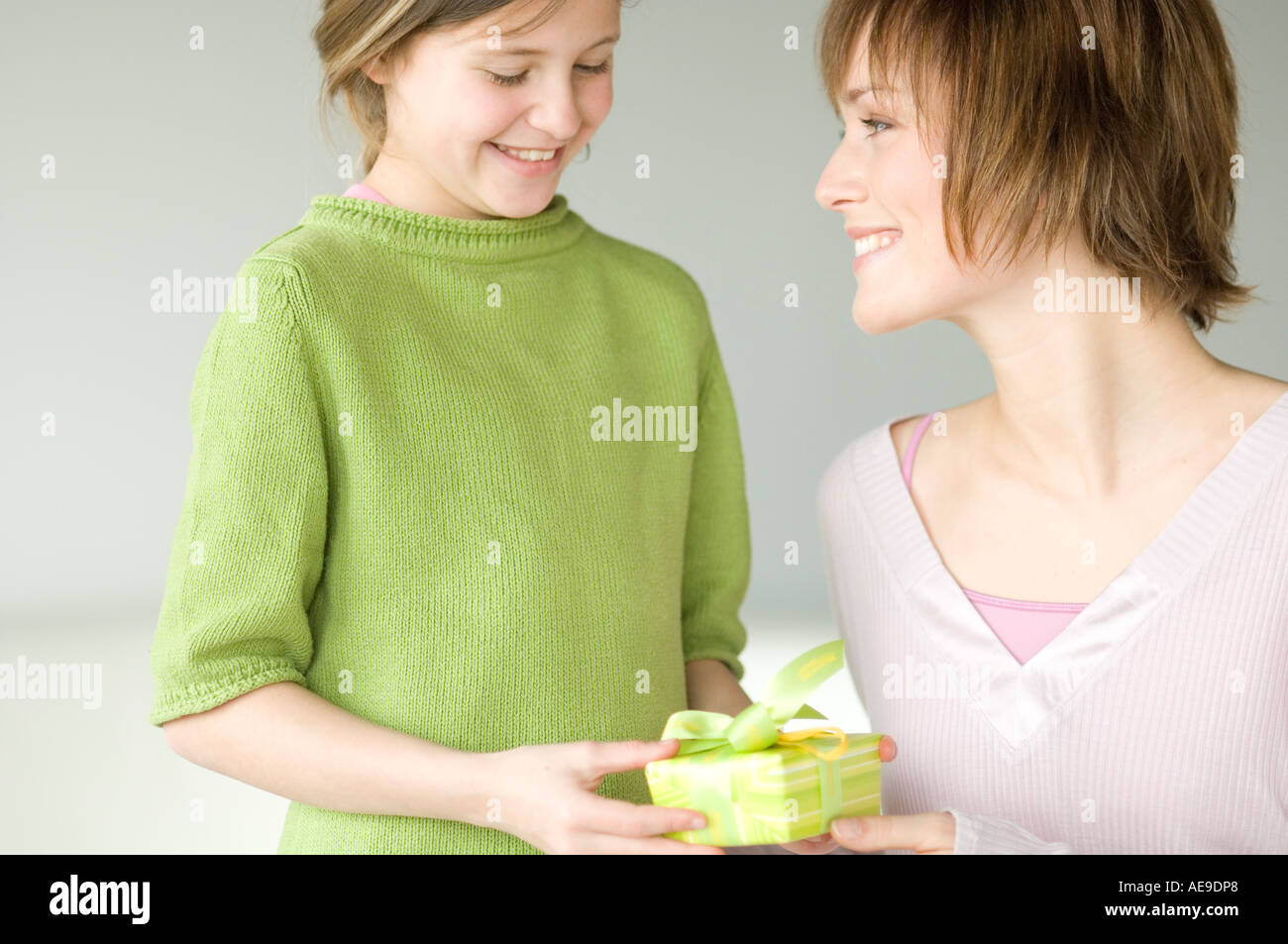 Little girl giving present to woman Stock Photo - Alamy