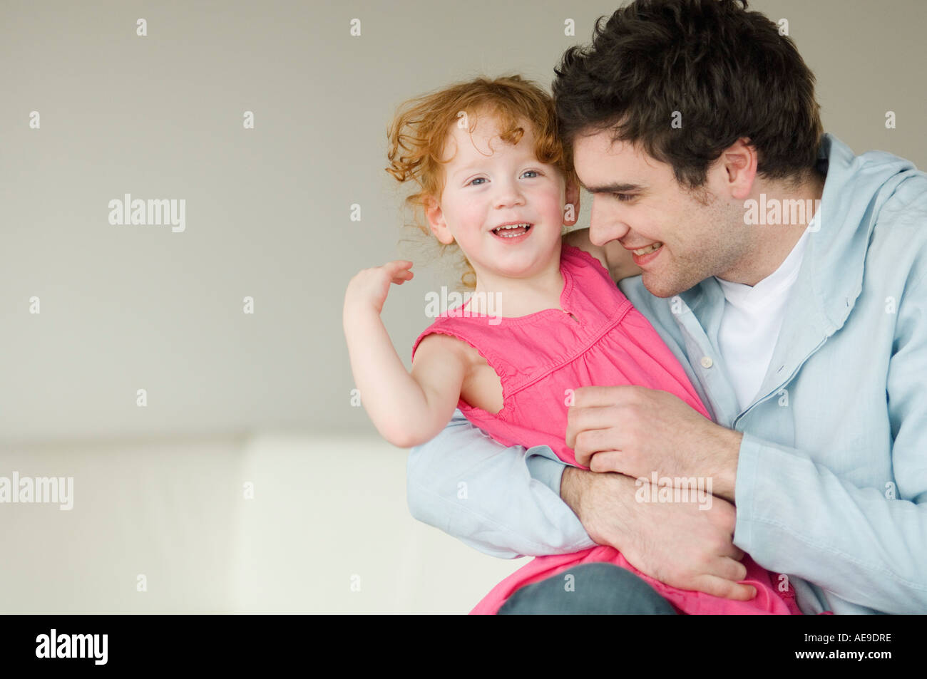 Man and little girl embracing Stock Photo - Alamy