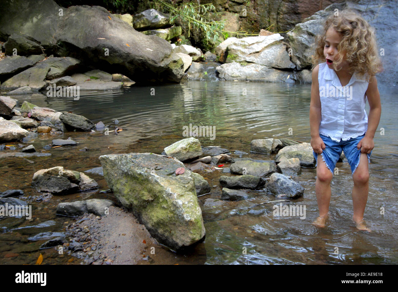Girl playing in waterfall hi-res stock photography and images - Alamy