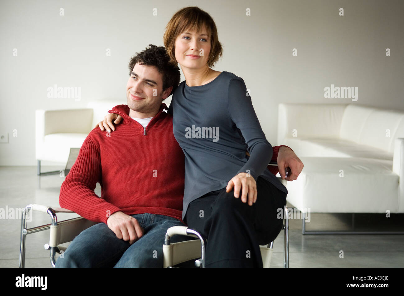 Couple embracing in armchair hi-res stock photography and images - Alamy