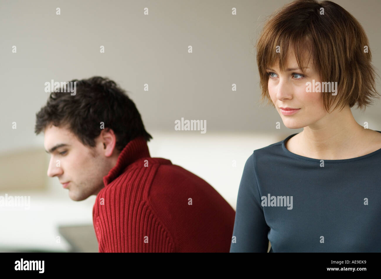 Sad looking couple in a living-room Stock Photo - Alamy