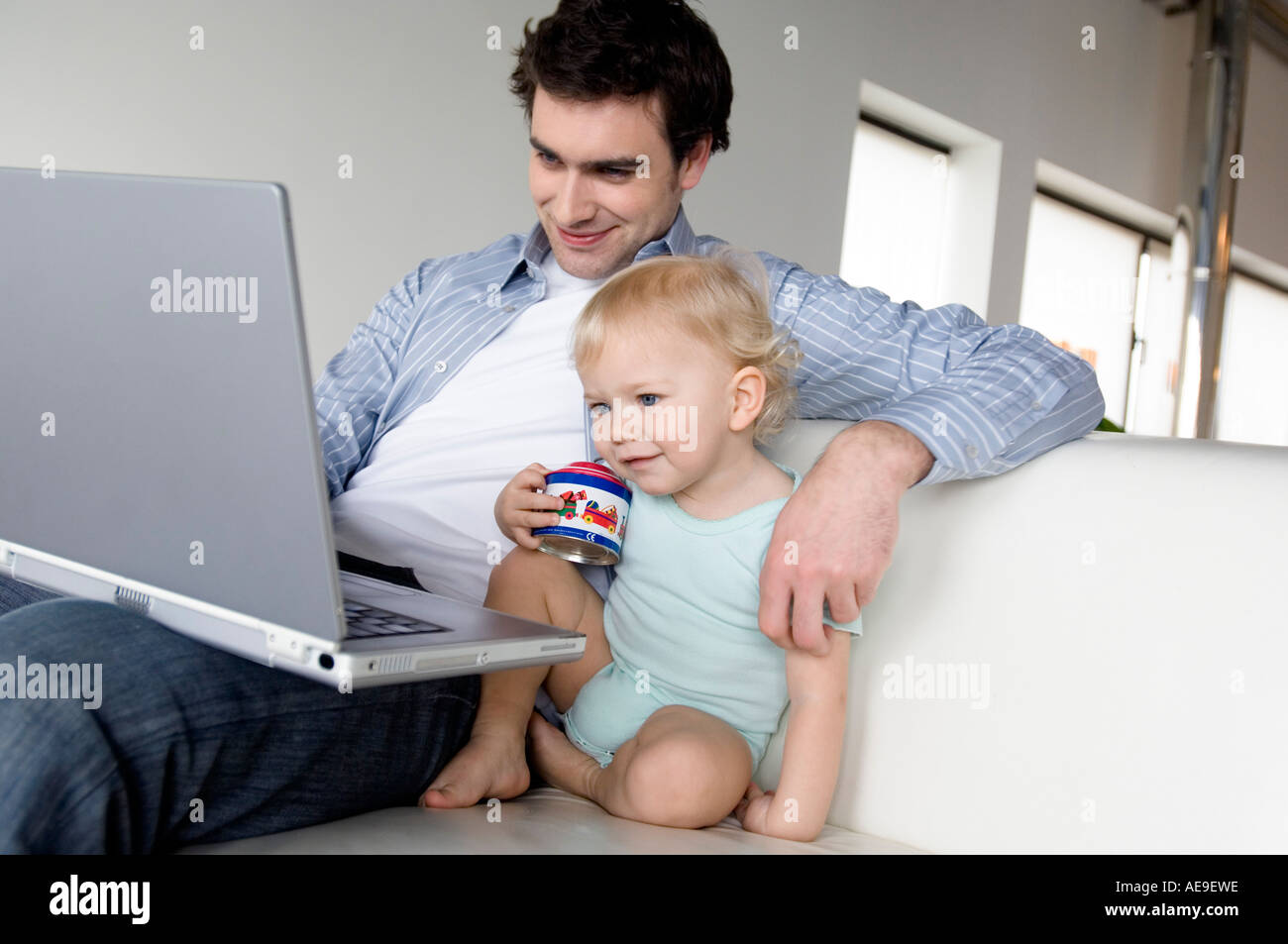 Man and little boy using laptop computer Stock Photo - Alamy