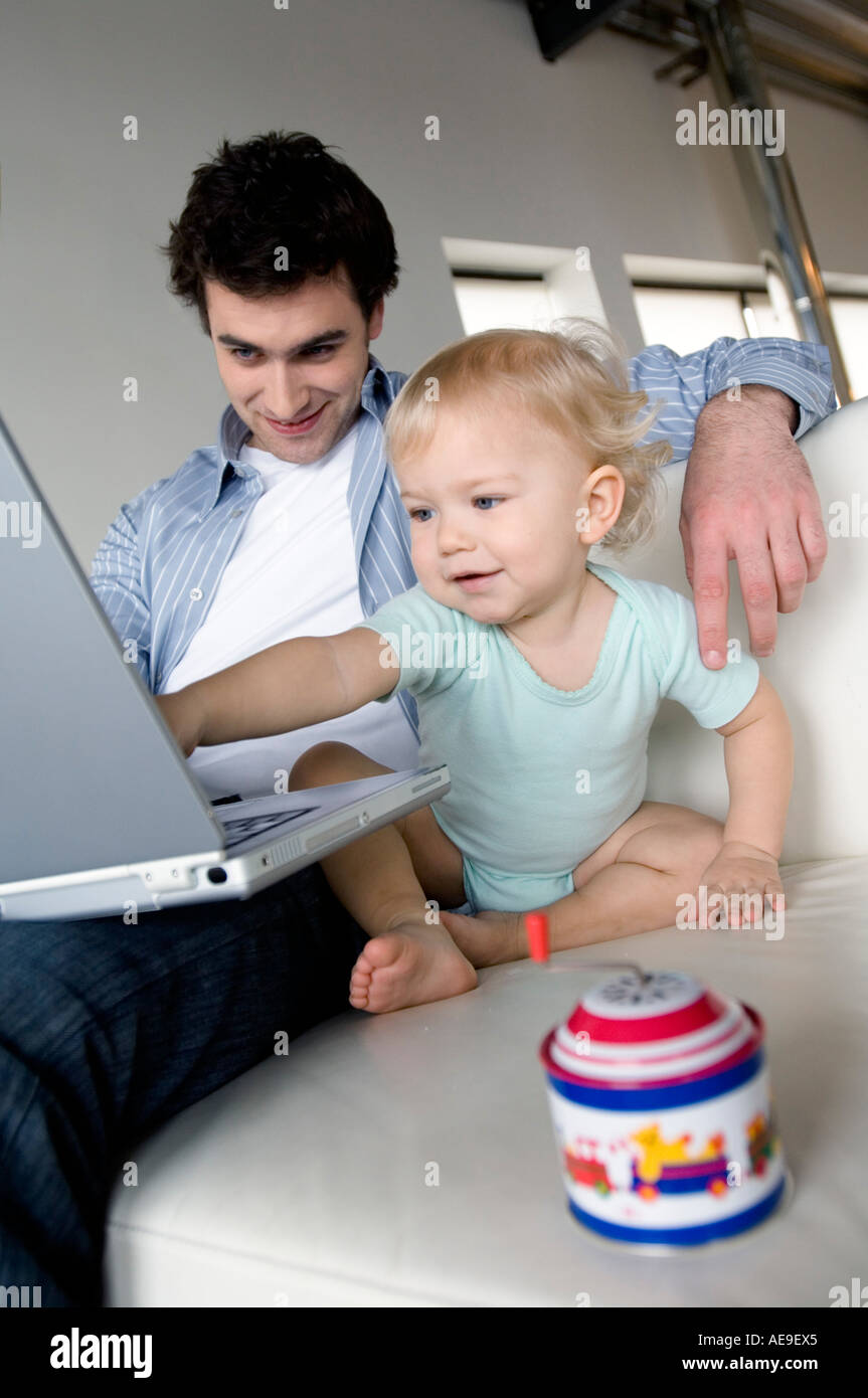 Man and little boy using laptop computer Stock Photo - Alamy