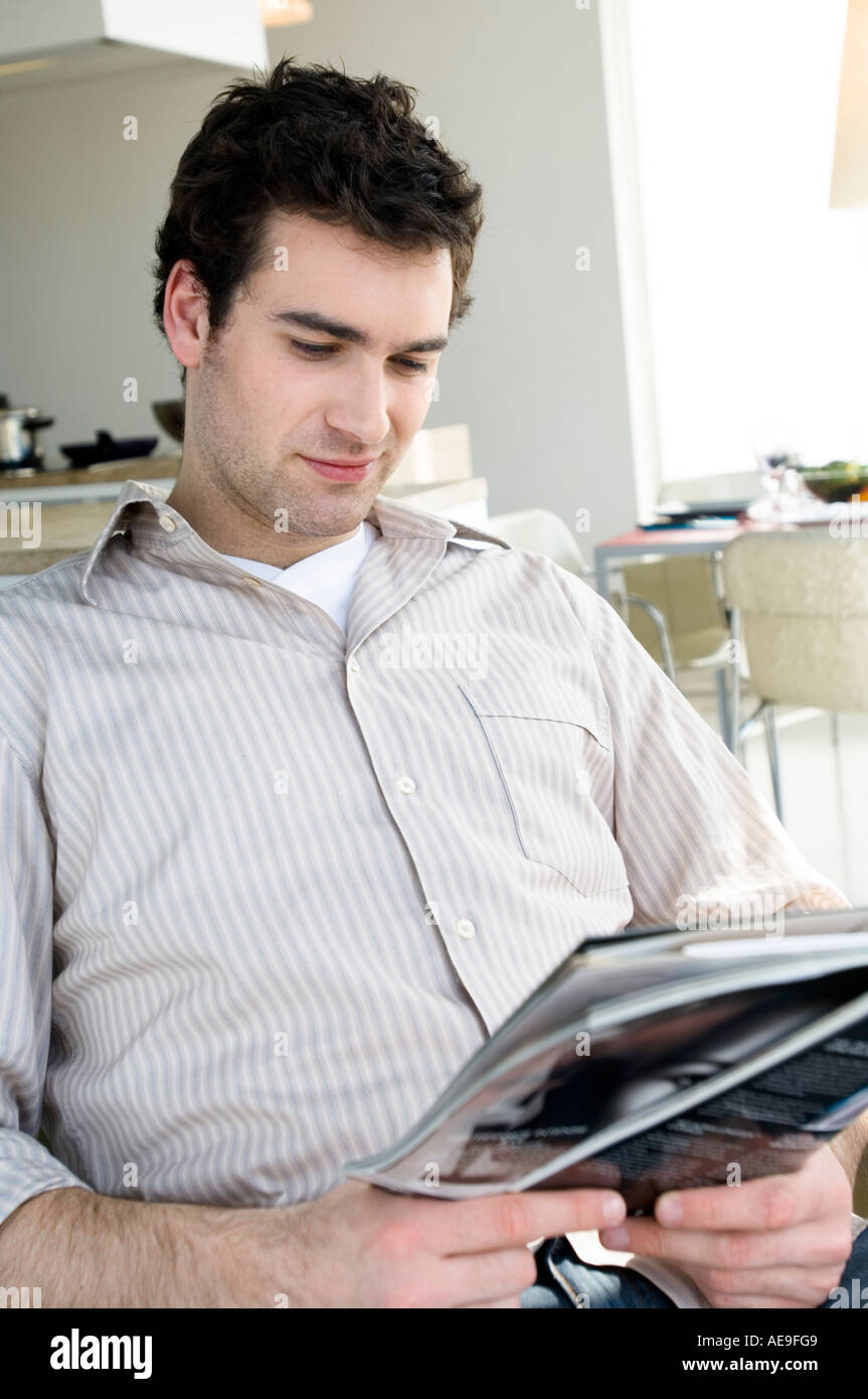 Man reading a magazine Stock Photo - Alamy