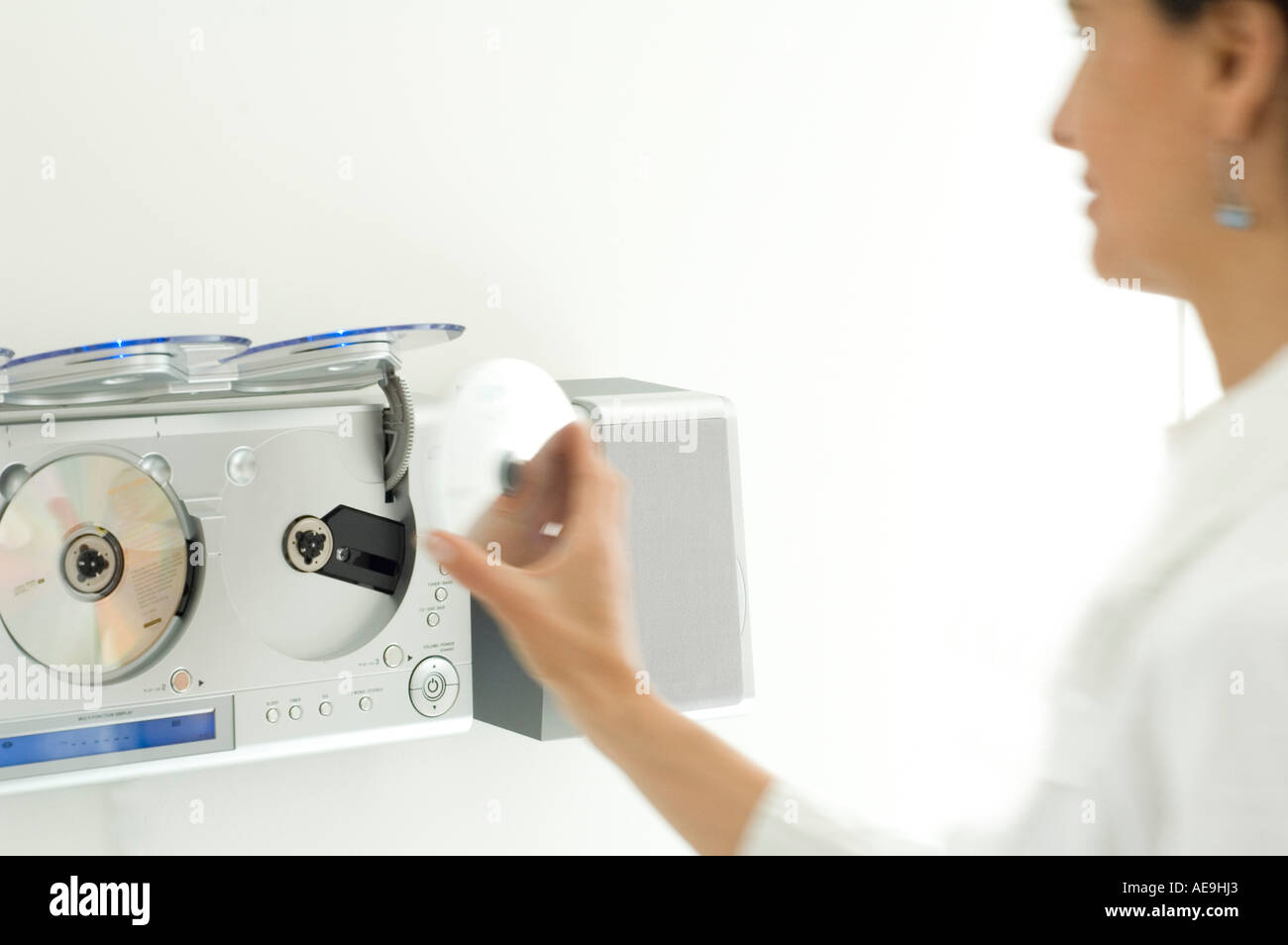 Woman using a CD player Stock Photo - Alamy