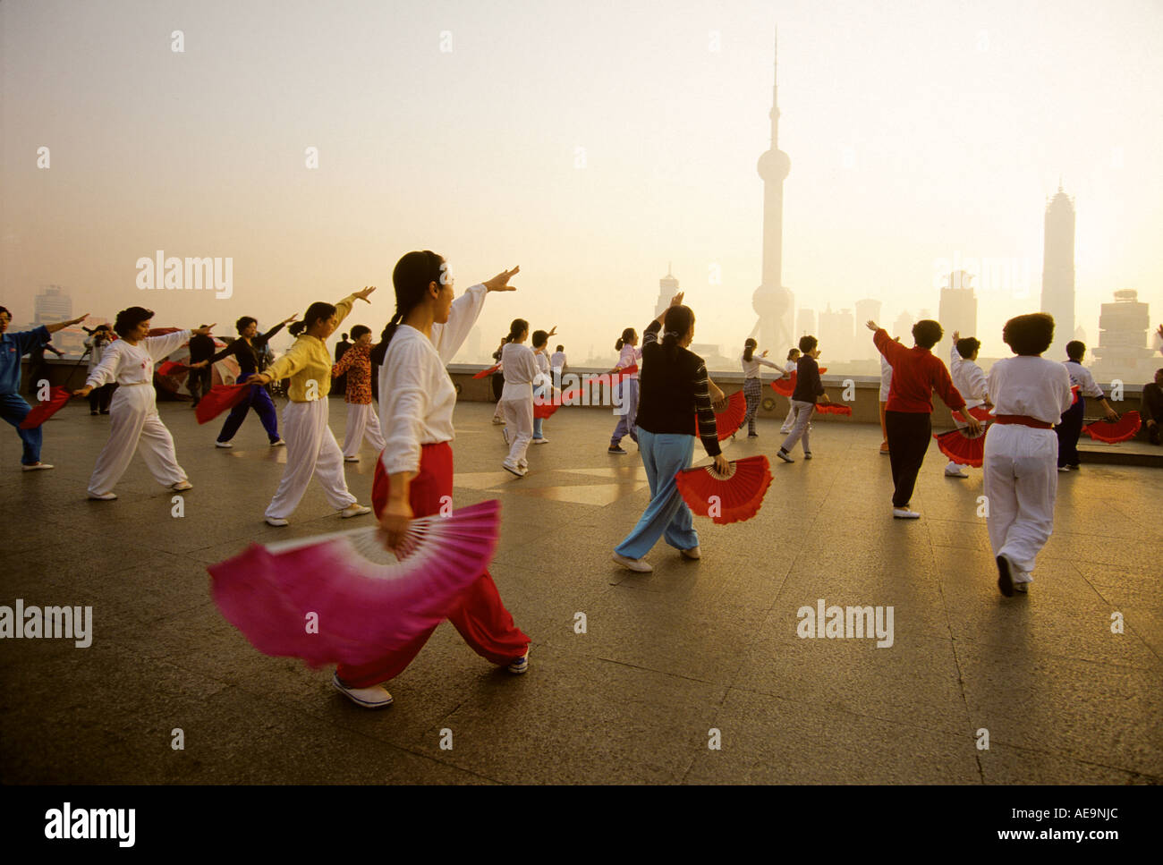 Shanghai Bund morning exercise group with Pudong skyline in background ...