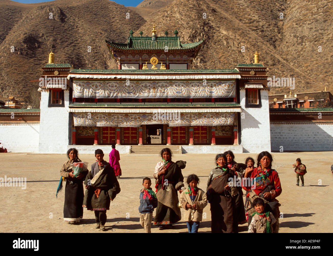 Tibetan Nomads walking past large Prayer Hall, Labrang Monastery, Xiahe ...