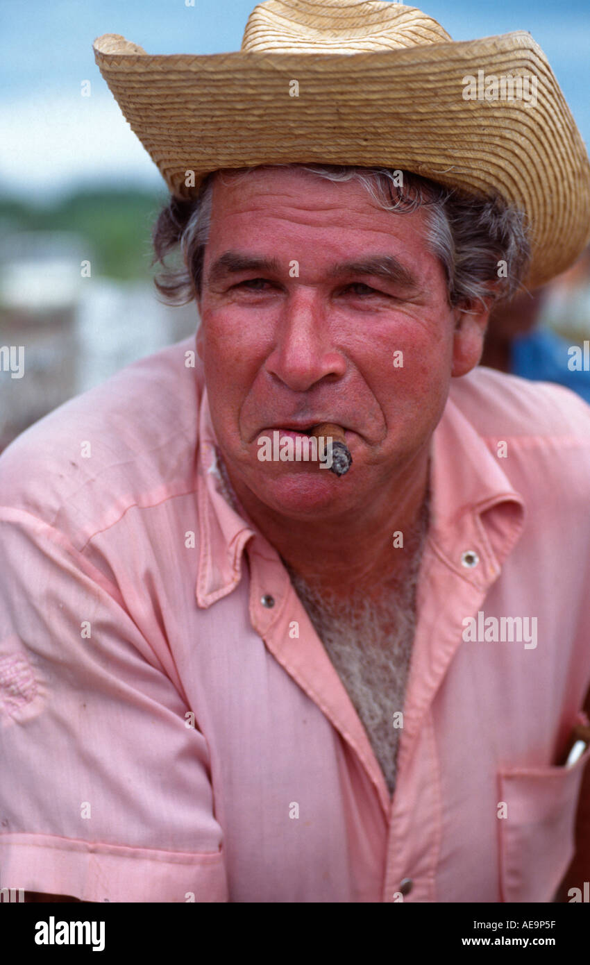 Old man smoking a cigar in a pink shirt at a country rodeo at Rodas ...