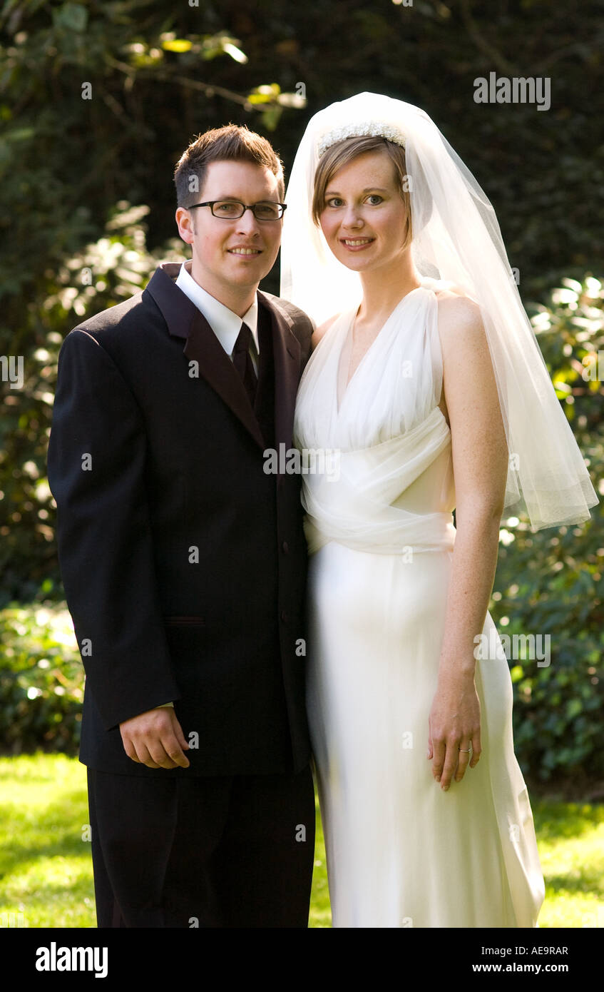 Portrait of bride and bride groom taken on their wedding day backlit by ...