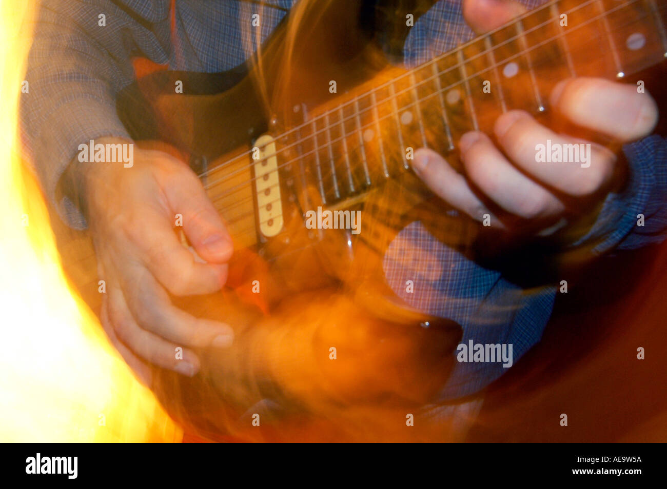 man male playing electric guitar showing motion movement against red ...