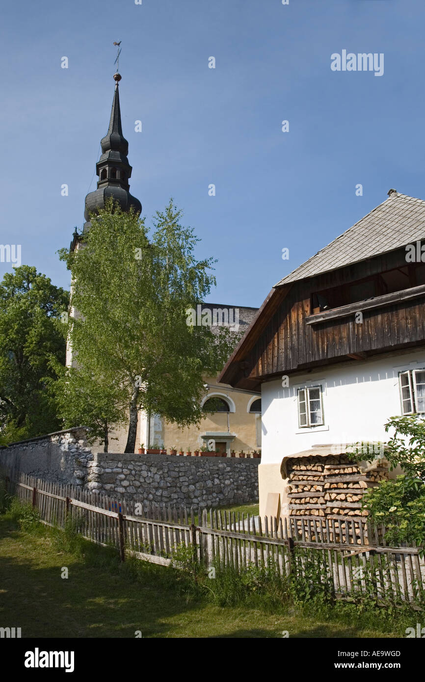 Kranjska Gora Slovenia. Traditional house with log store beside Church ...
