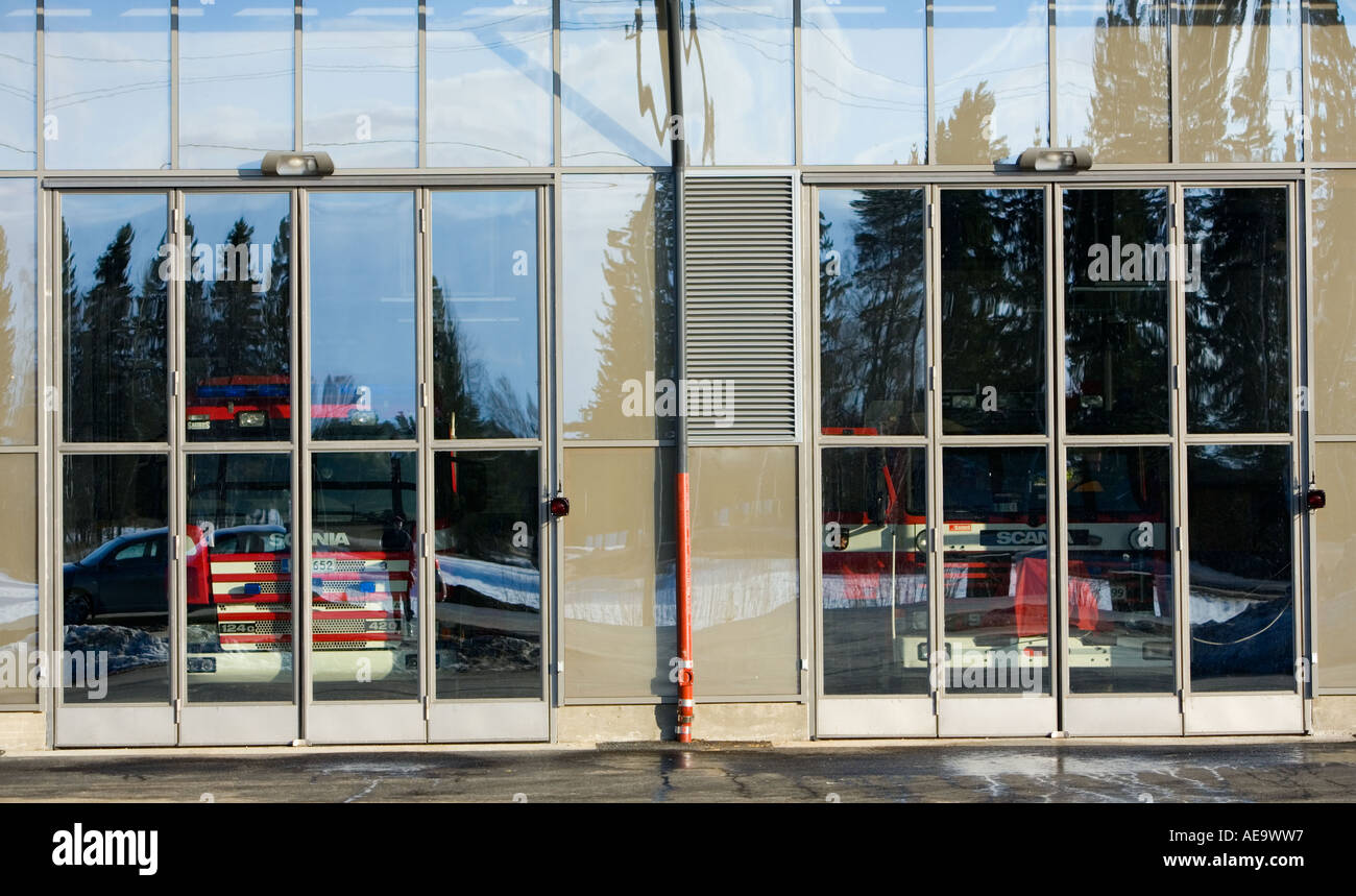 Fire department trucks behind closed garage glass doors , Finland Stock ...