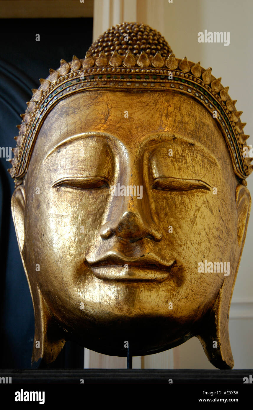 small statue of buddha in house showing only face Stock Photo - Alamy